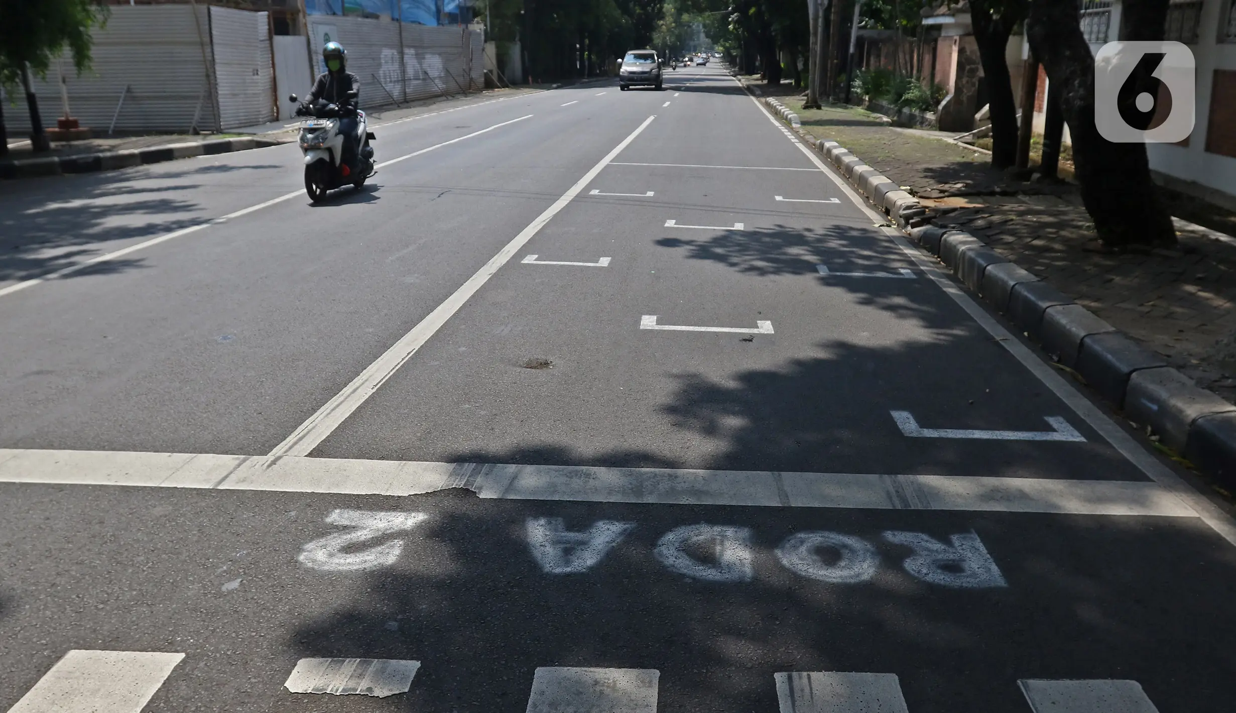 FOTO: Garis Pembatas Antarpengendara Motor di Jakarta - Foto Liputan6.com